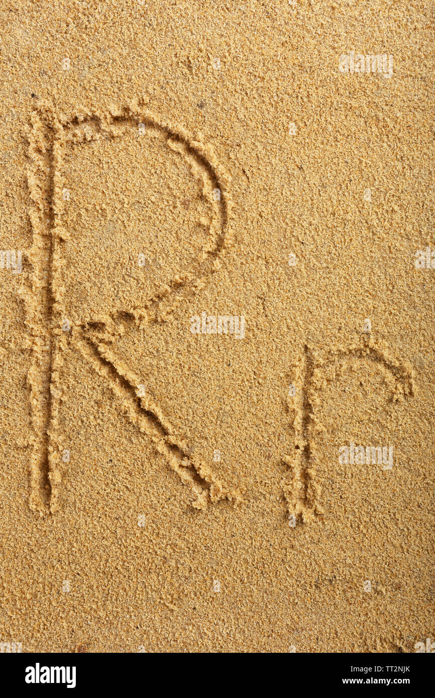 Alphabet letter written on wet beach sand Stock Photo - Alamy