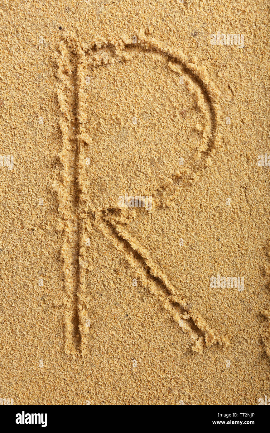 Alphabet letter written on wet beach sand Stock Photo - Alamy