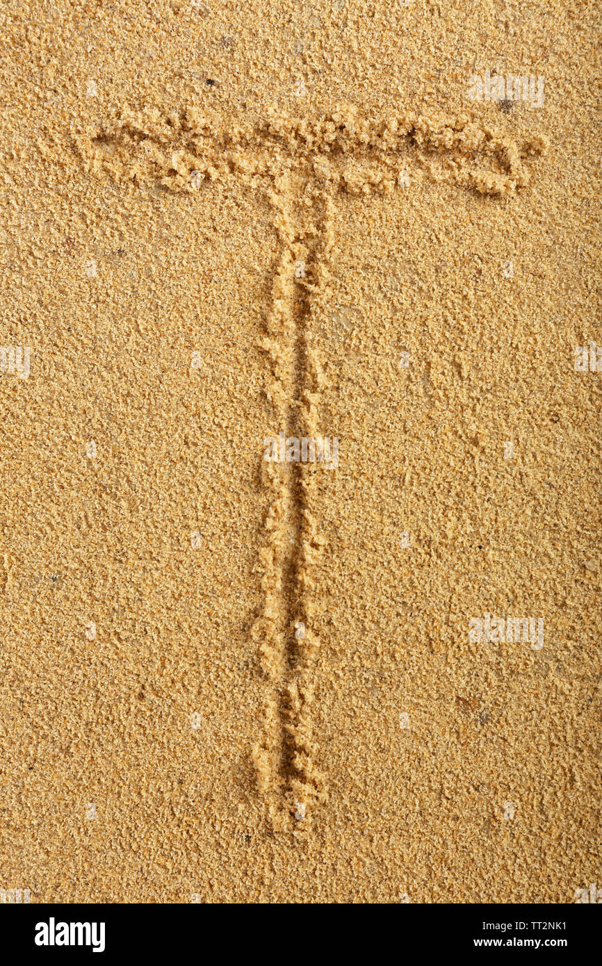 Alphabet letter written on wet beach sand Stock Photo - Alamy