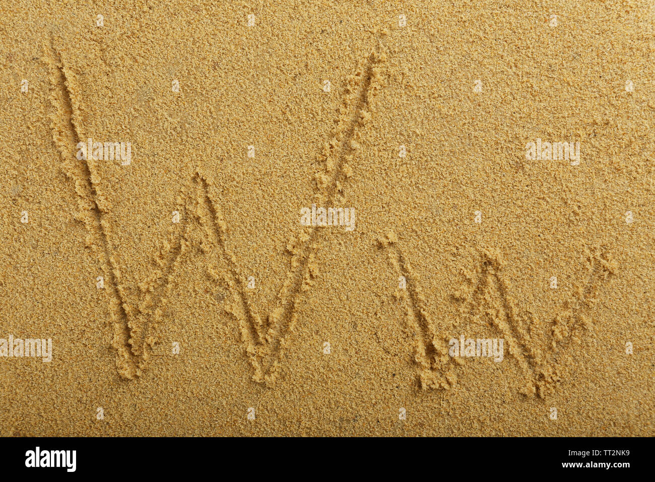 Alphabet letter written on wet beach sand Stock Photo - Alamy