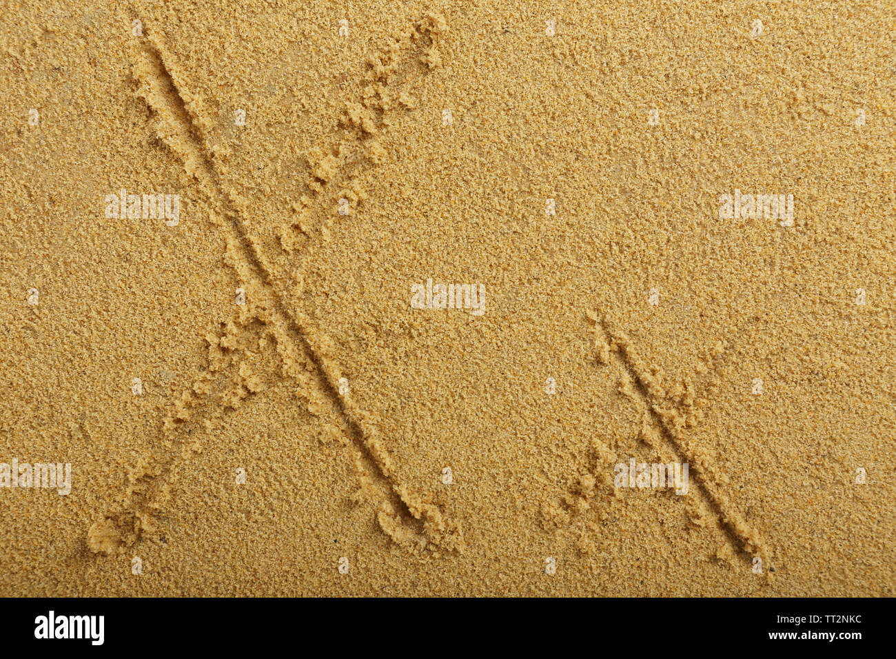 Alphabet letter written on wet beach sand Stock Photo - Alamy