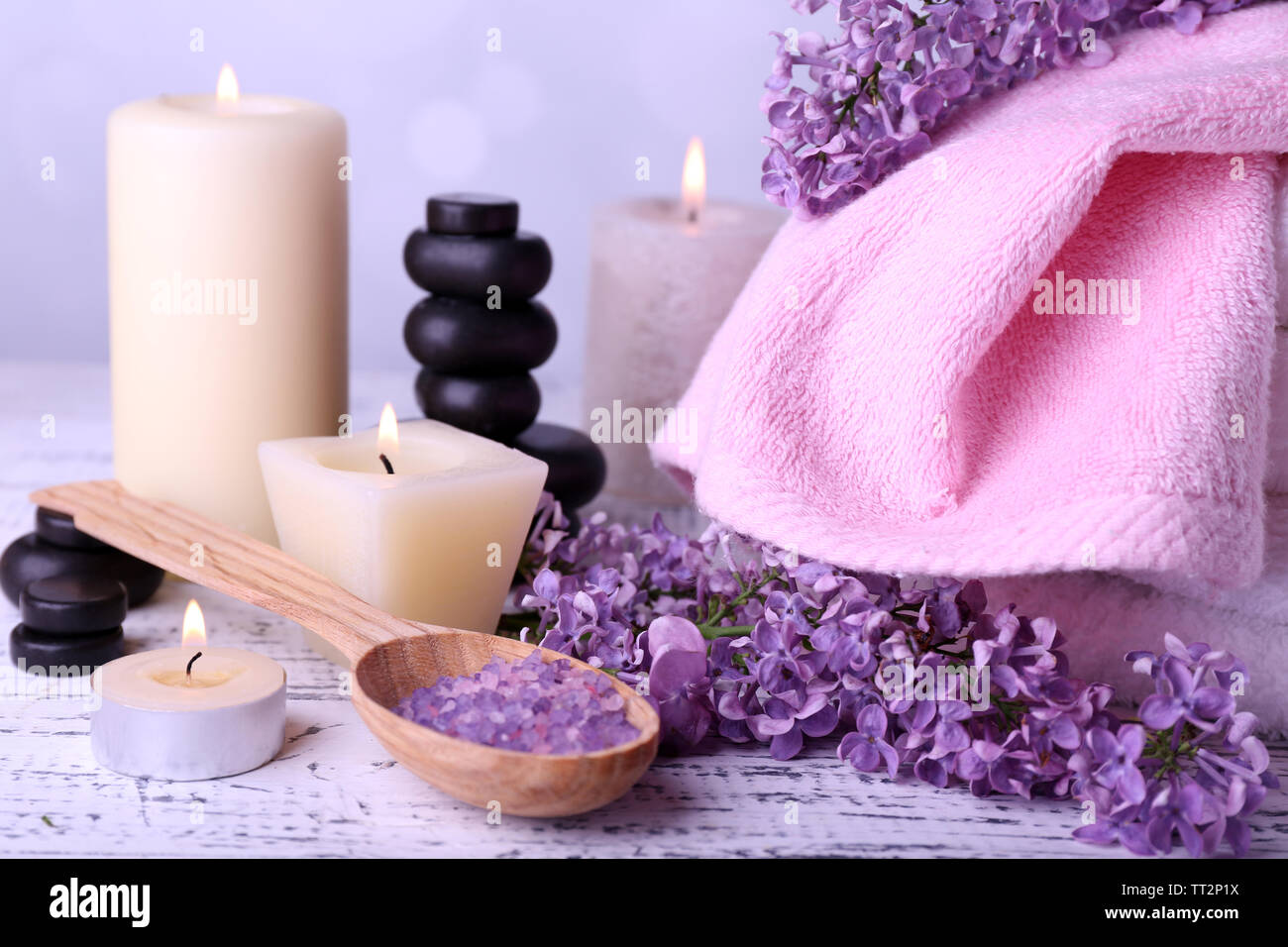 Composition with spa treatment, towels and lilac flowers, on light ...