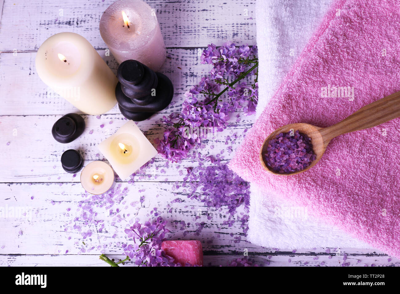 Composition with spa treatment, towels and lilac flowers, on light ...