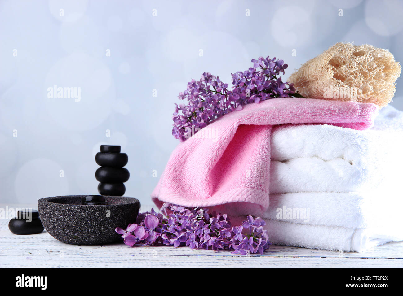 Composition with spa treatment, towels and lilac flowers, on light ...