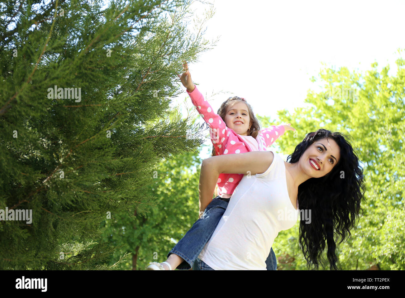 Happy mom and daughter. Walk in the green park Stock Photo - Alamy