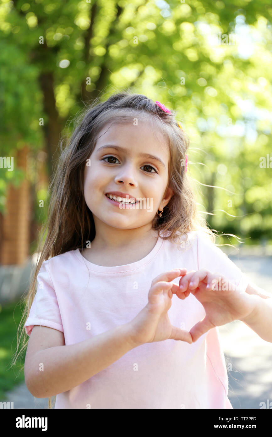 Happy little girl in the green park Stock Photo - Alamy