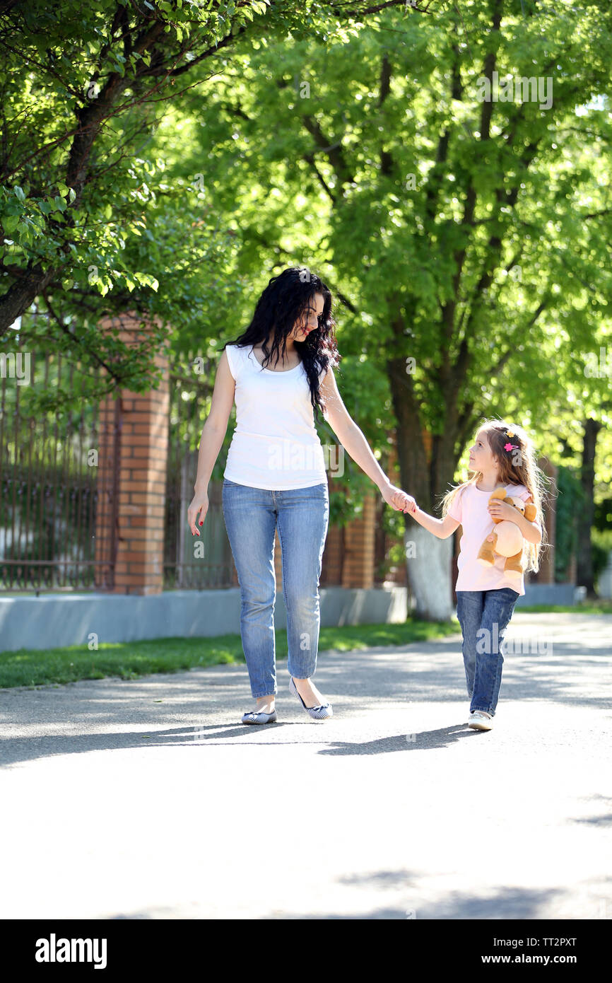 Happy mom and daughter. Walk in the green park Stock Photo - Alamy