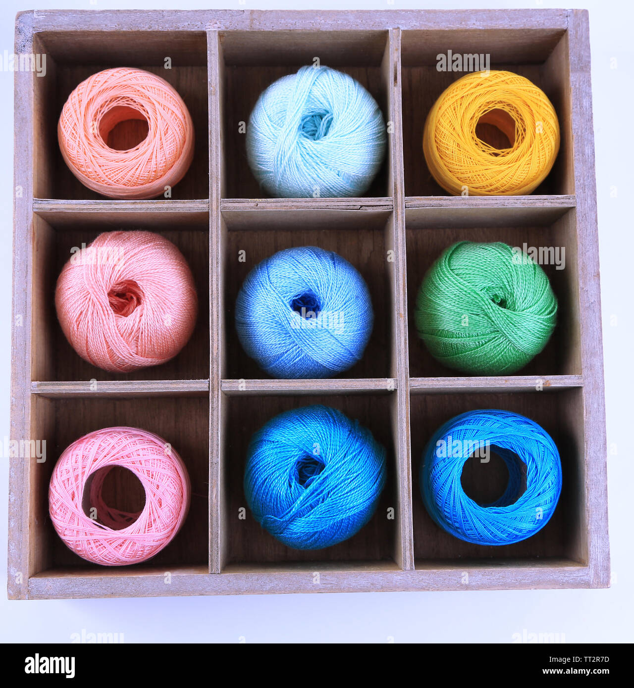 Colorful clews in wooden box isolated on white Stock Photo - Alamy