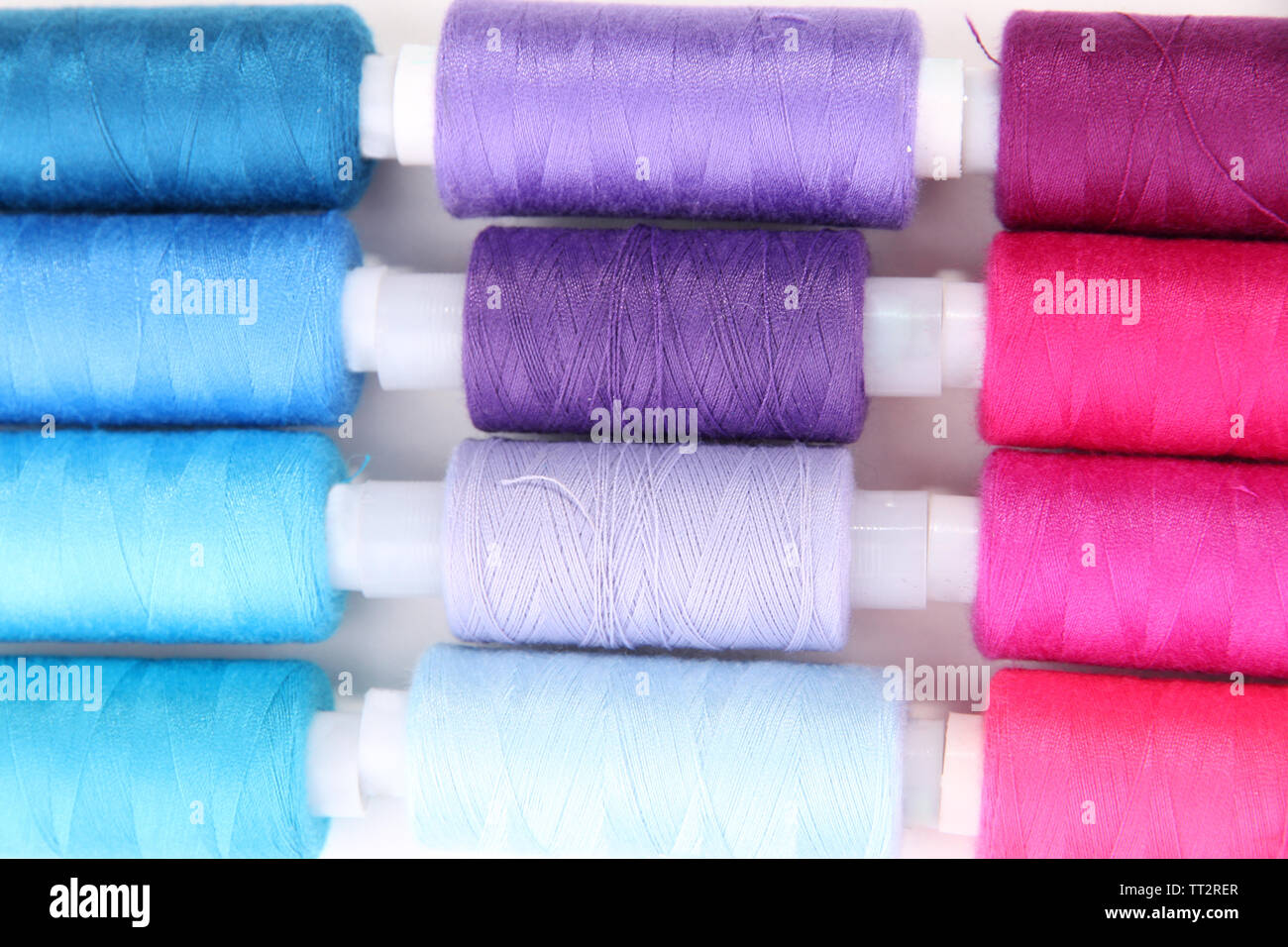 Multicolor sewing threads background Stock Photo - Alamy
