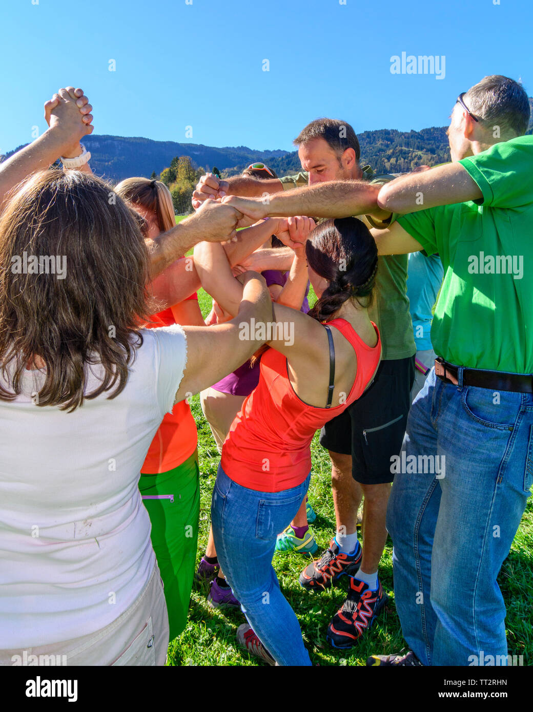 Funny and tricky knot game during team training Stock Photo - Alamy