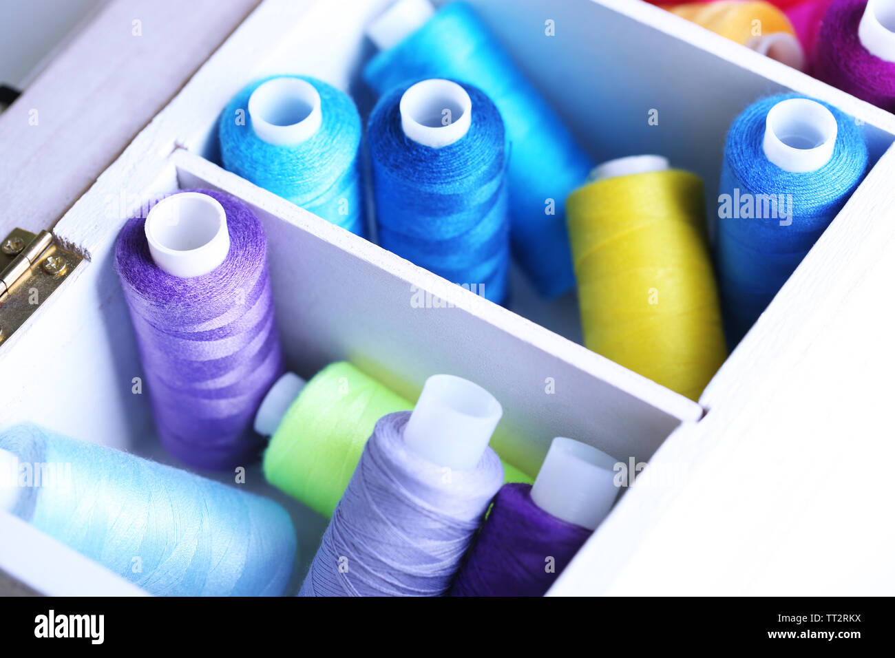 Multicolor sewing thread in wooden box, close-up Stock Photo - Alamy