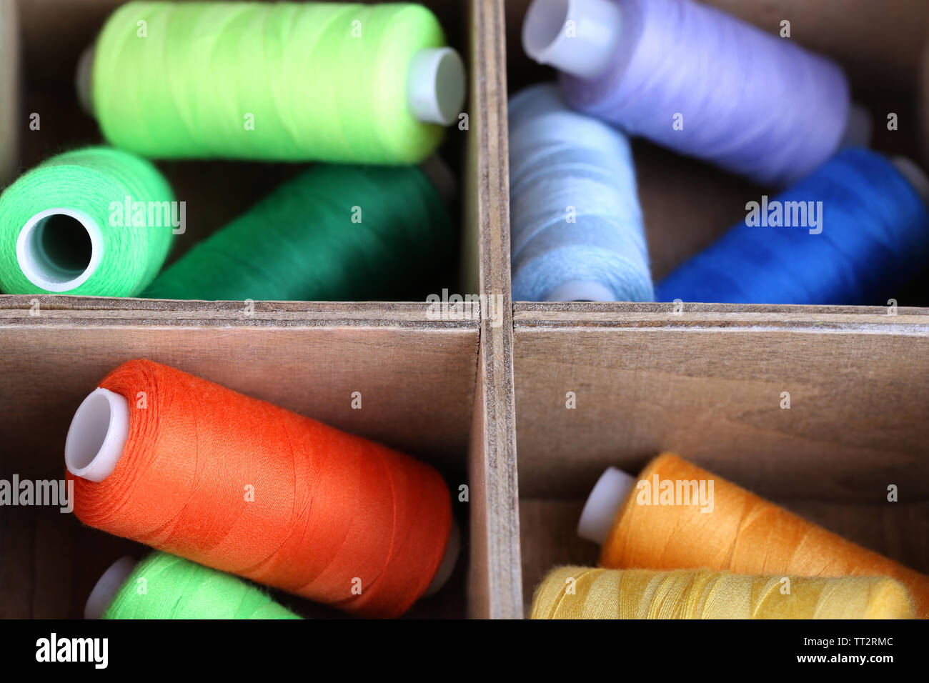 Multicolor sewing thread in wooden box, close-up Stock Photo - Alamy