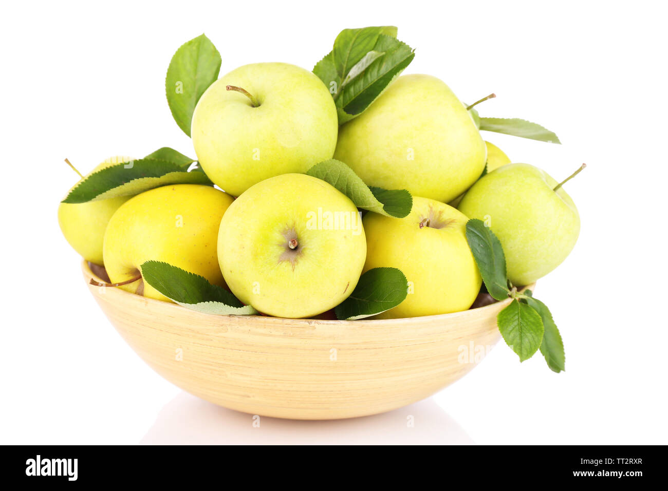 Ripe sweet apples with leaves in wooden bowl, isolated on white Stock ...