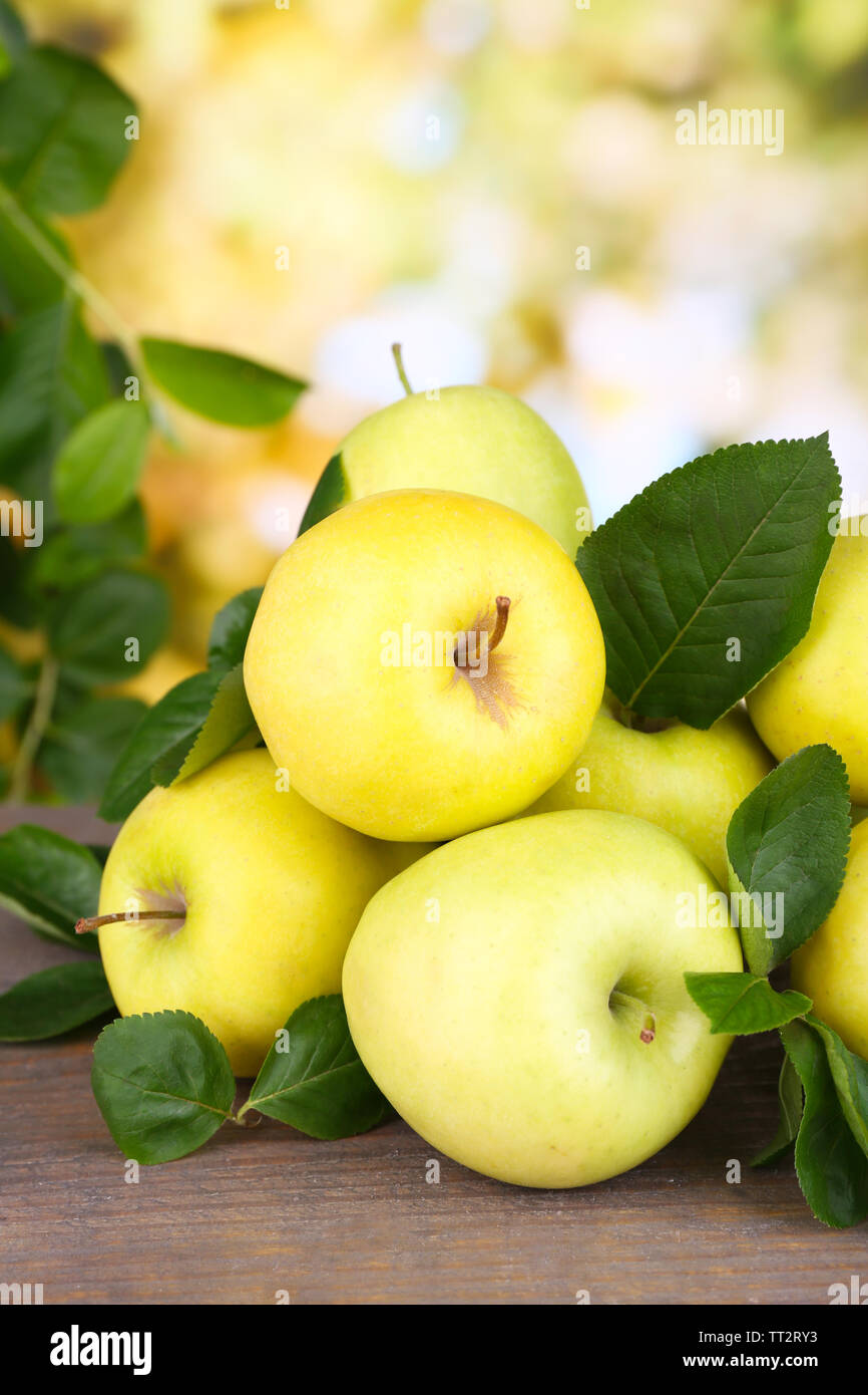 Ripe sweet apples with leaves on nature background Stock Photo - Alamy