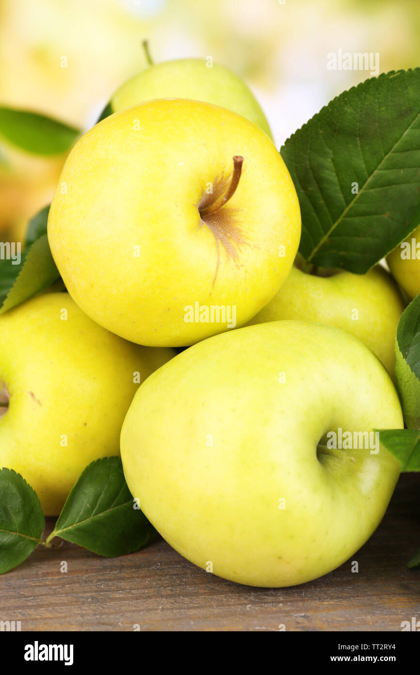 Ripe sweet apples with leaves on nature background Stock Photo - Alamy