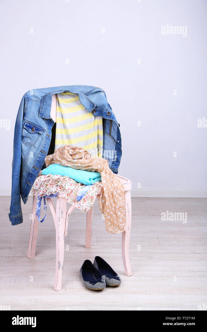 Clothes on chair on gray background Stock Photo - Alamy
