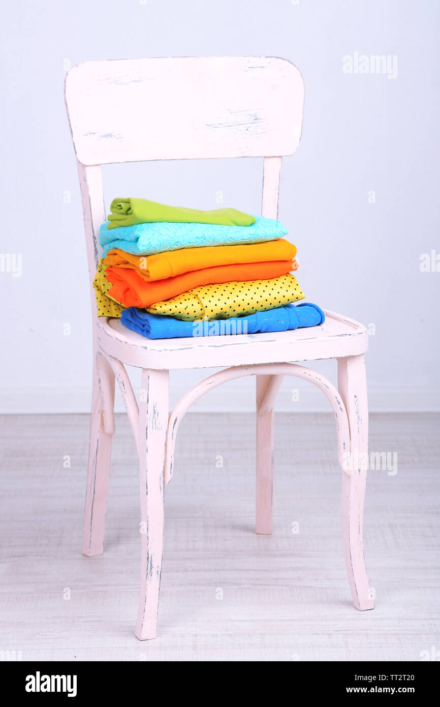 Clothes on chair on gray background Stock Photo - Alamy