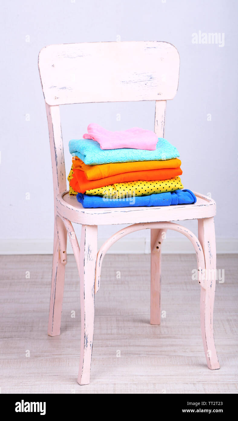 Clothes on chair on gray background Stock Photo - Alamy