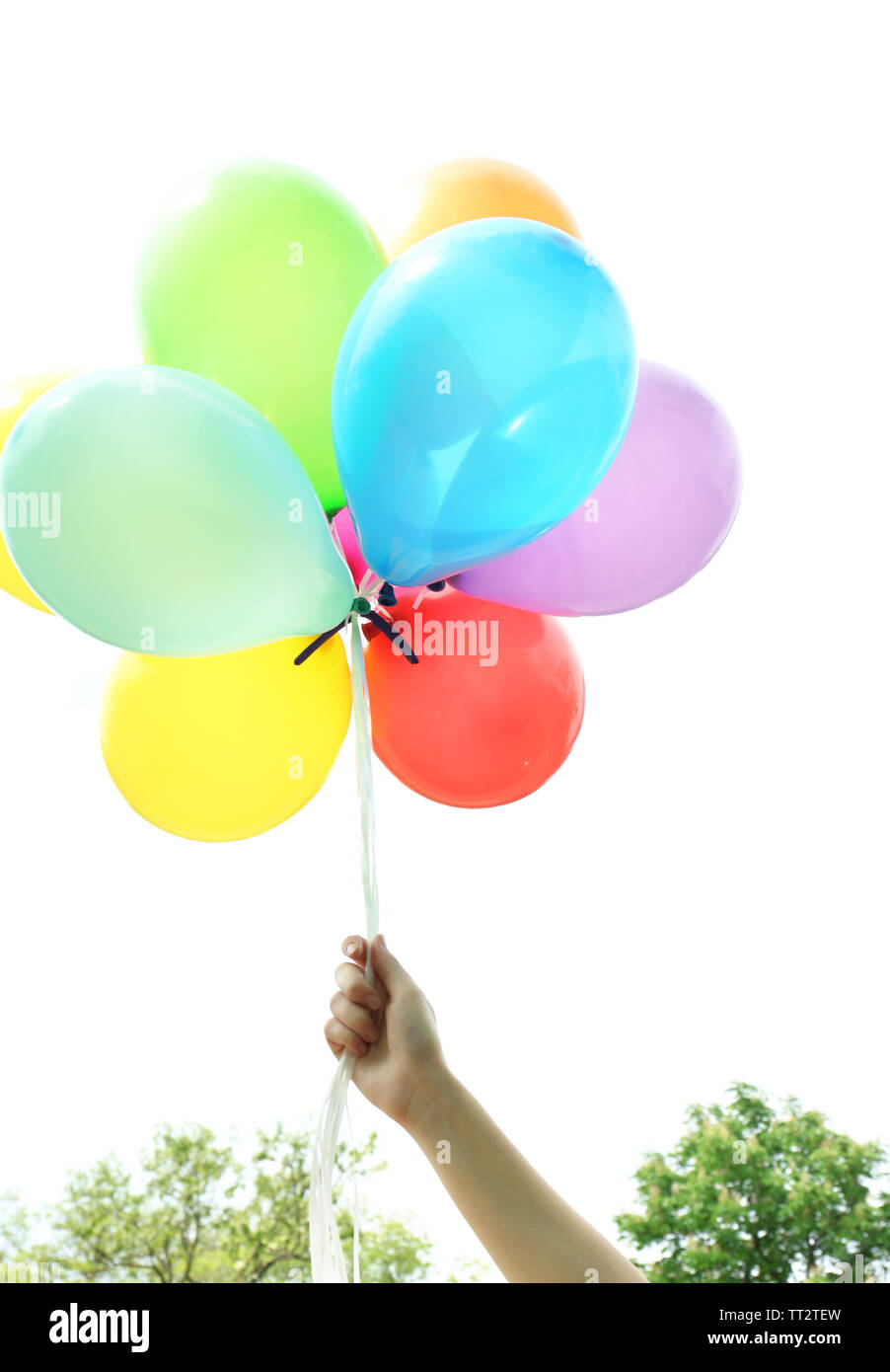 Balloons in hand, outdoors Stock Photo - Alamy