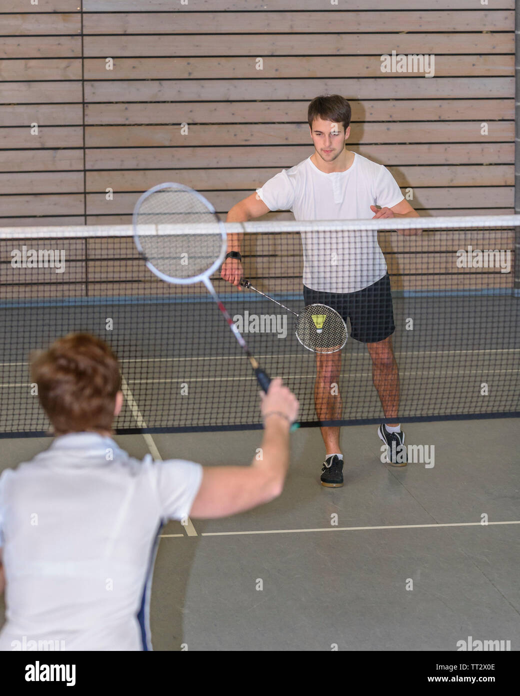 Badminton game scene in sports hall, a lot of effort and commitment ...