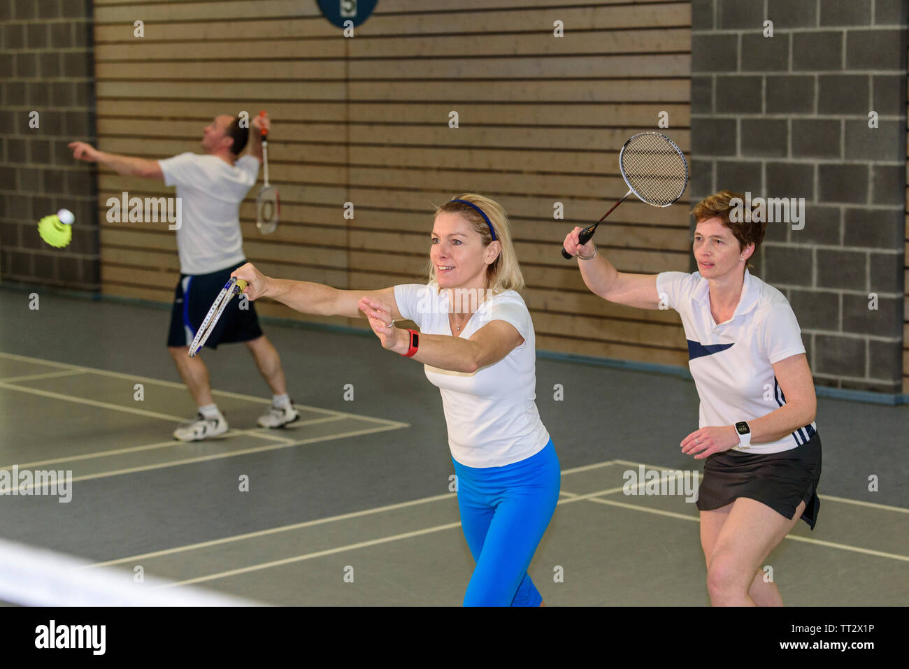 Badminton game scene in sports hall, a lot of effort and commitment ...