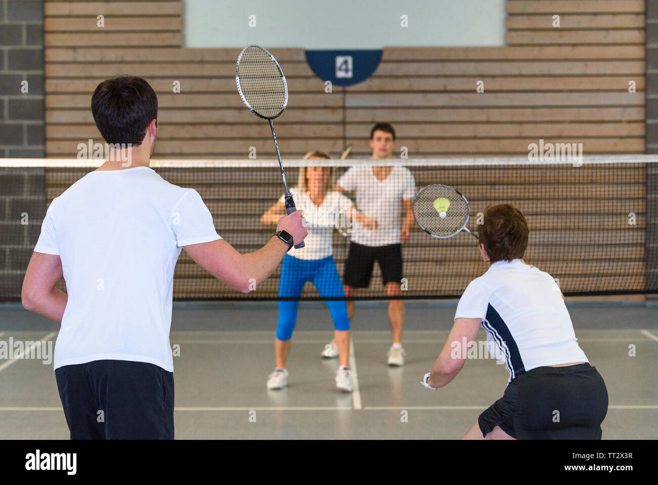 Badminton game scene in sports hall, a lot of effort and commitment ...
