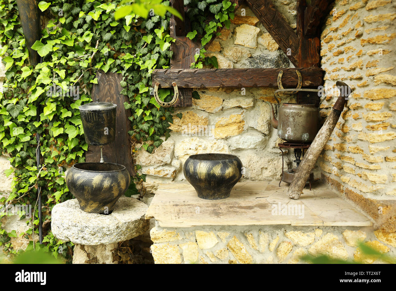 Old retro cauldrons in garden Stock Photo - Alamy