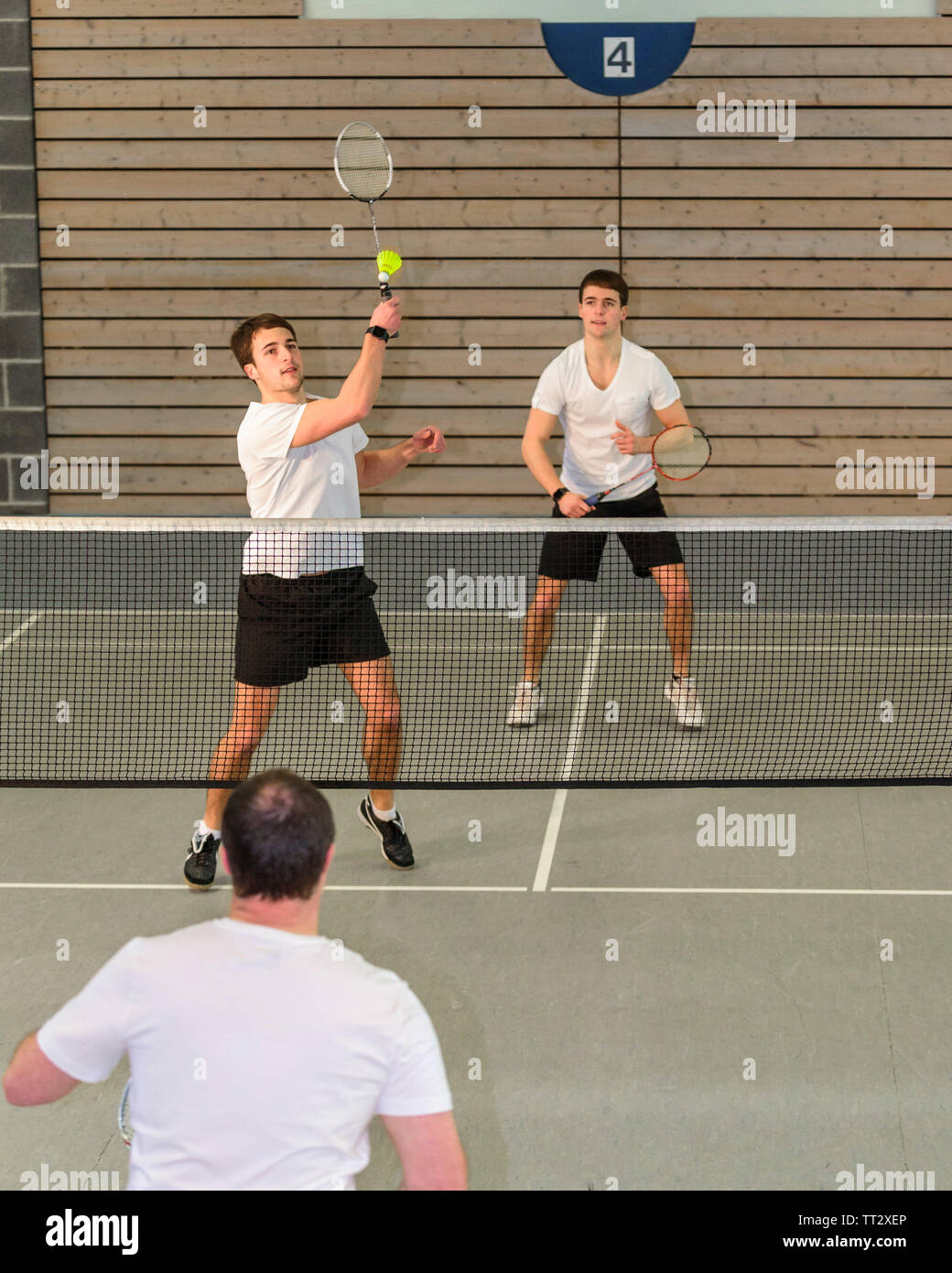 Badminton game scene in sports hall, a lot of effort and commitment ...