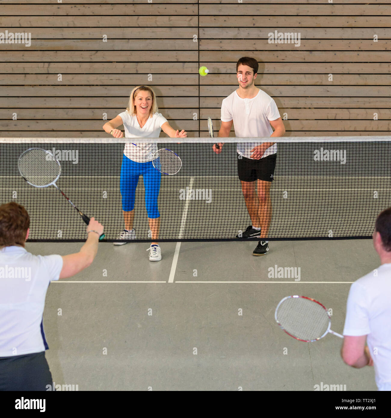 Badminton game scene in sports hall, a lot of effort and commitment ...