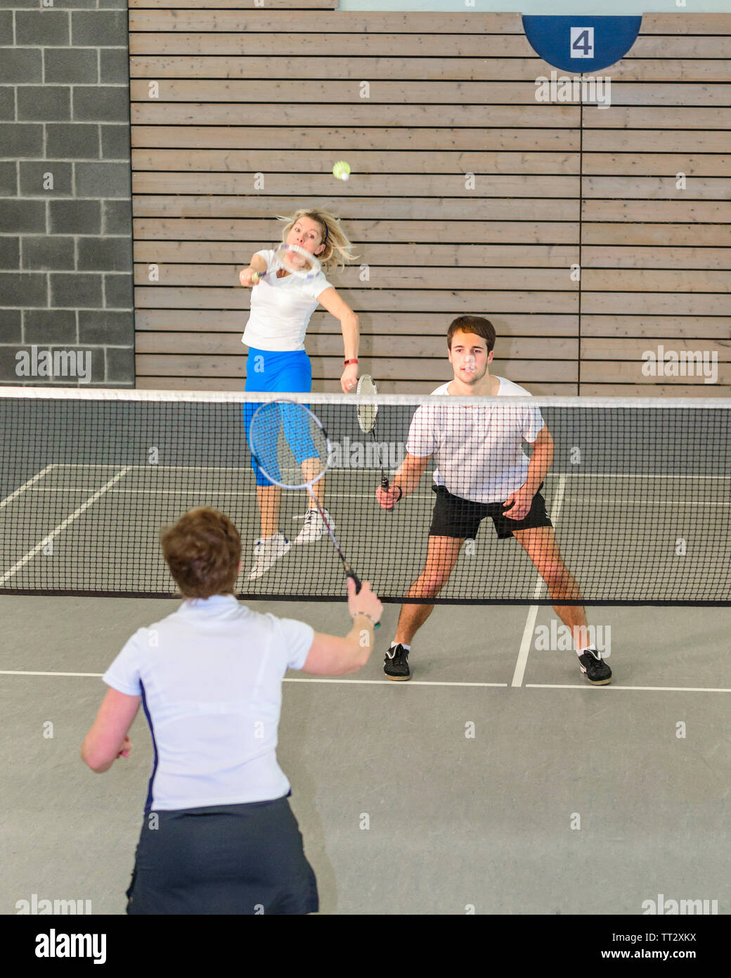 Badminton game scene in sports hall, a lot of effort and commitment ...