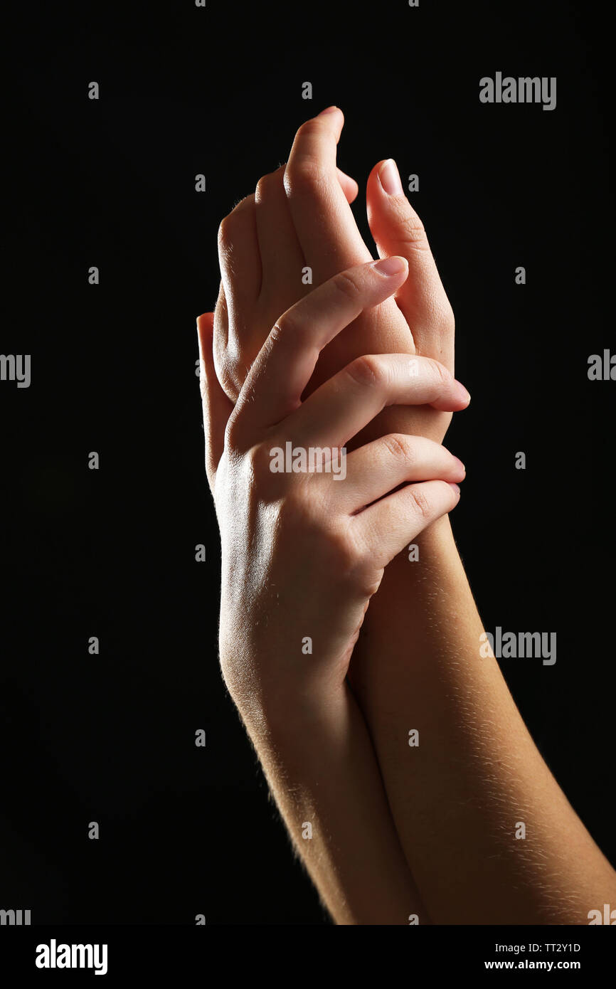 Human hands on black background Stock Photo - Alamy