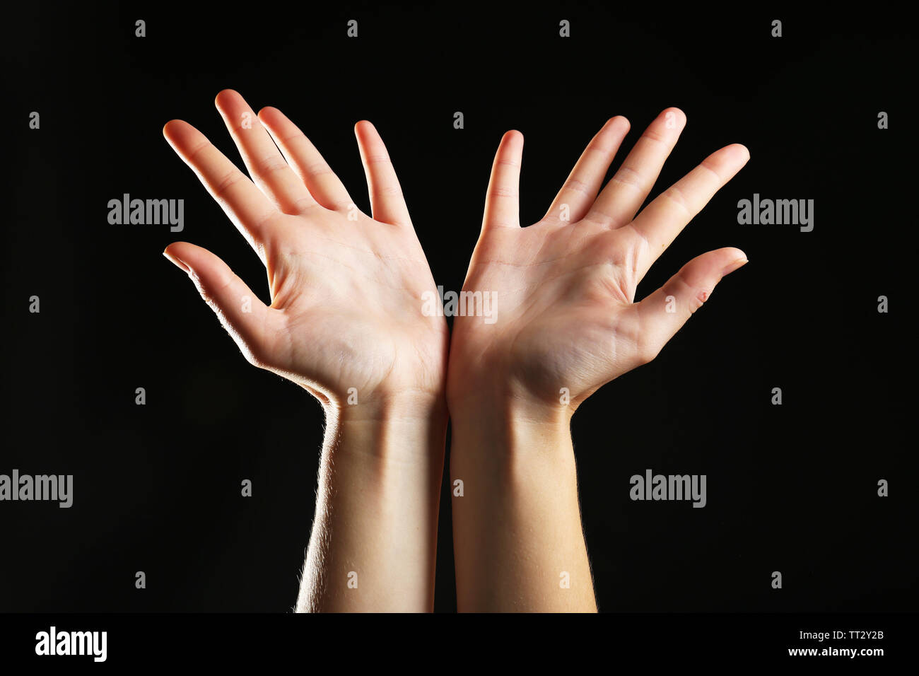 Human hands on black background Stock Photo - Alamy