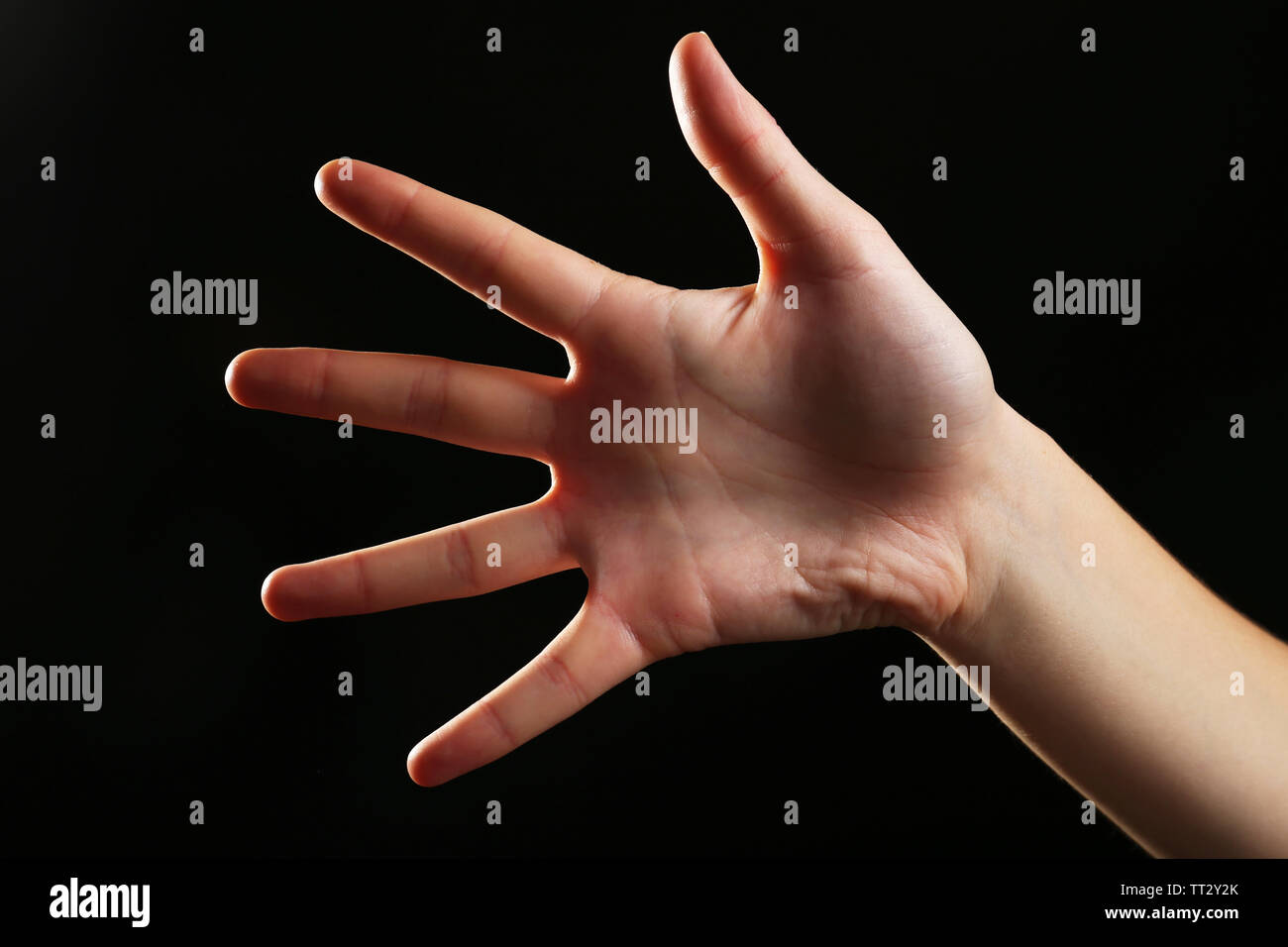 Human hand on black background Stock Photo - Alamy