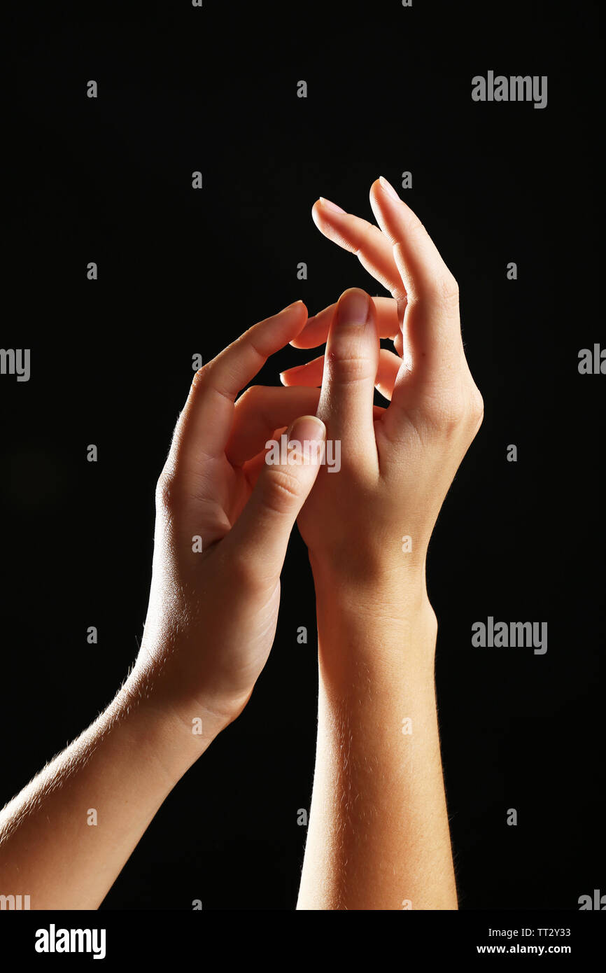 Human hands on black background Stock Photo - Alamy
