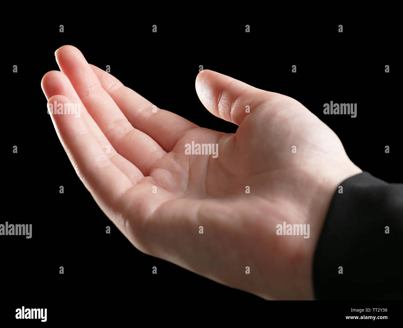 Human hand on black background Stock Photo - Alamy