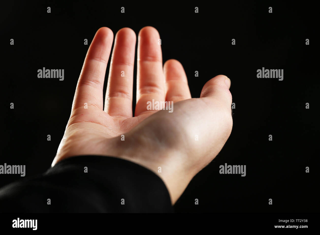 Human hand on black background Stock Photo - Alamy