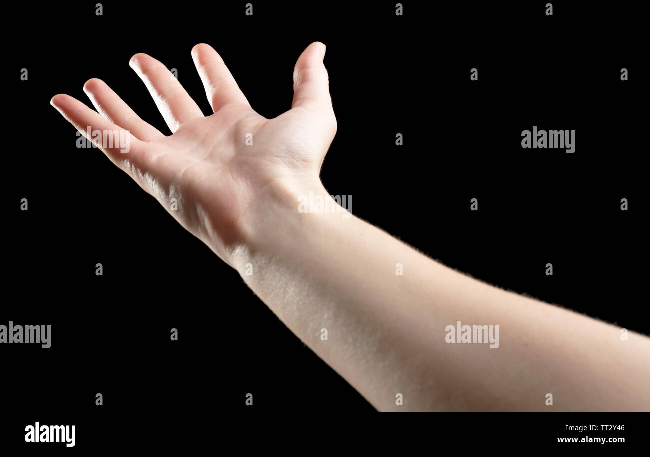 Human hand on black background Stock Photo - Alamy