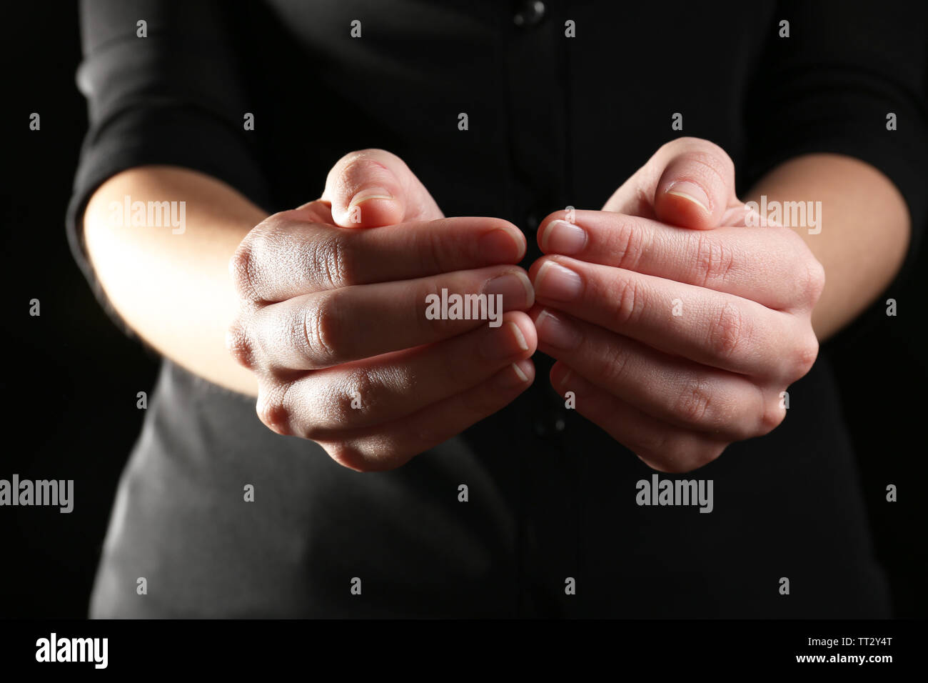 Human hands on black background Stock Photo - Alamy