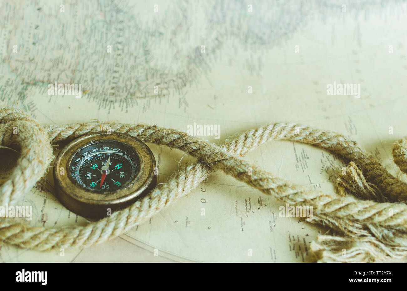 Vintage old compass and rope on the background of an old map from the ...