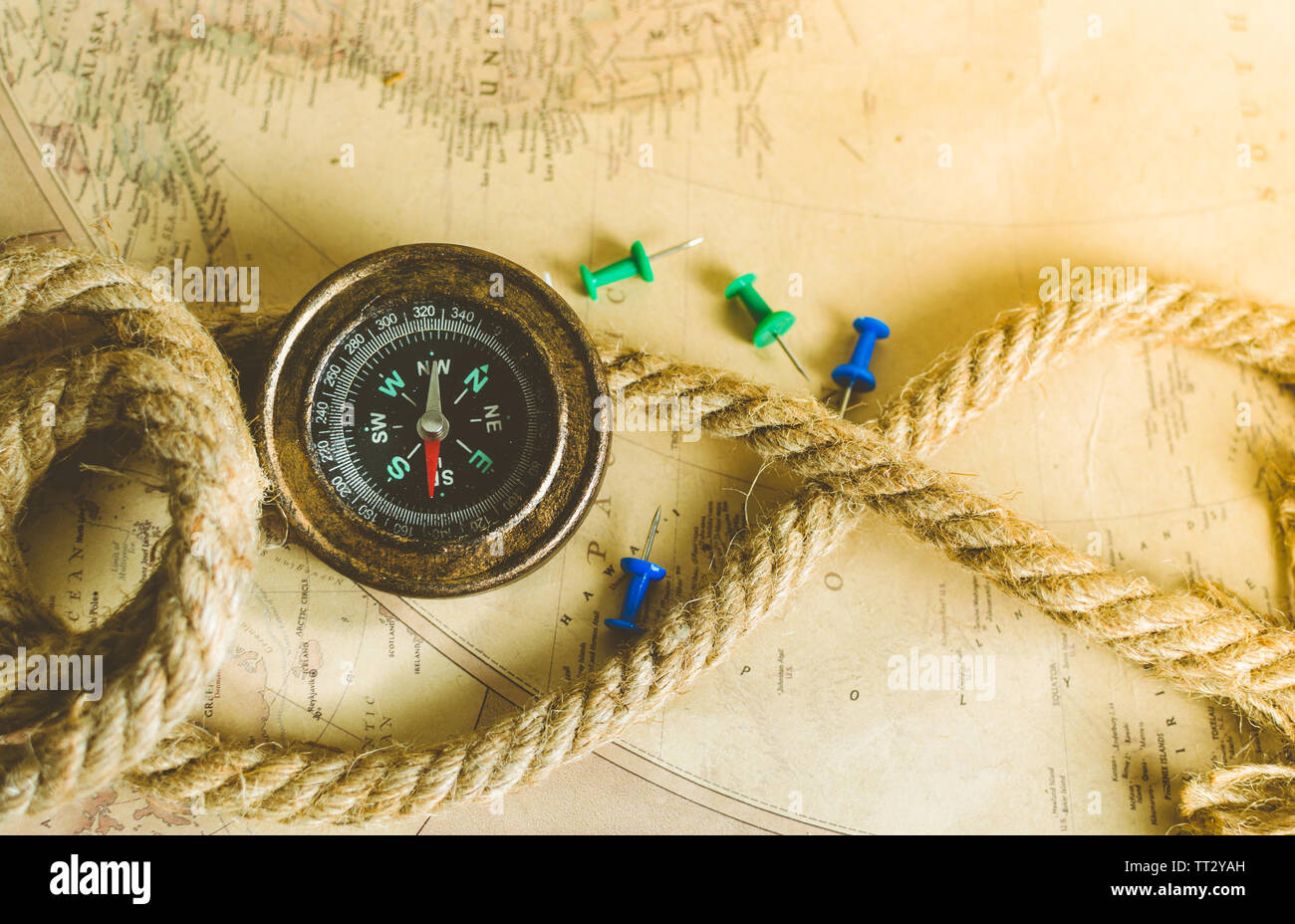 Old compass, rope and buttons on the map in the light of day Stock ...