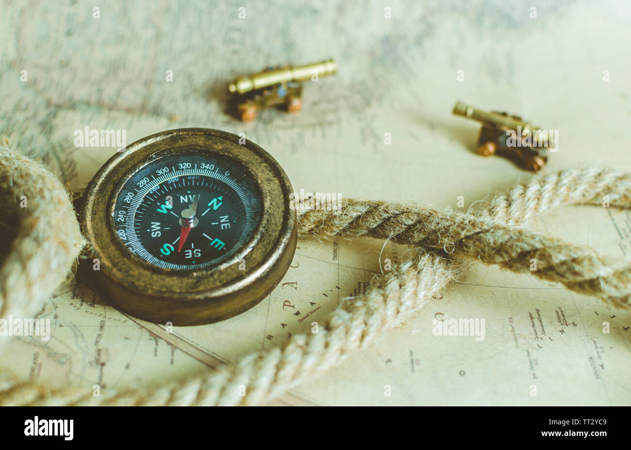 Old compass, rope and two ship cannons on the old map Stock Photo - Alamy