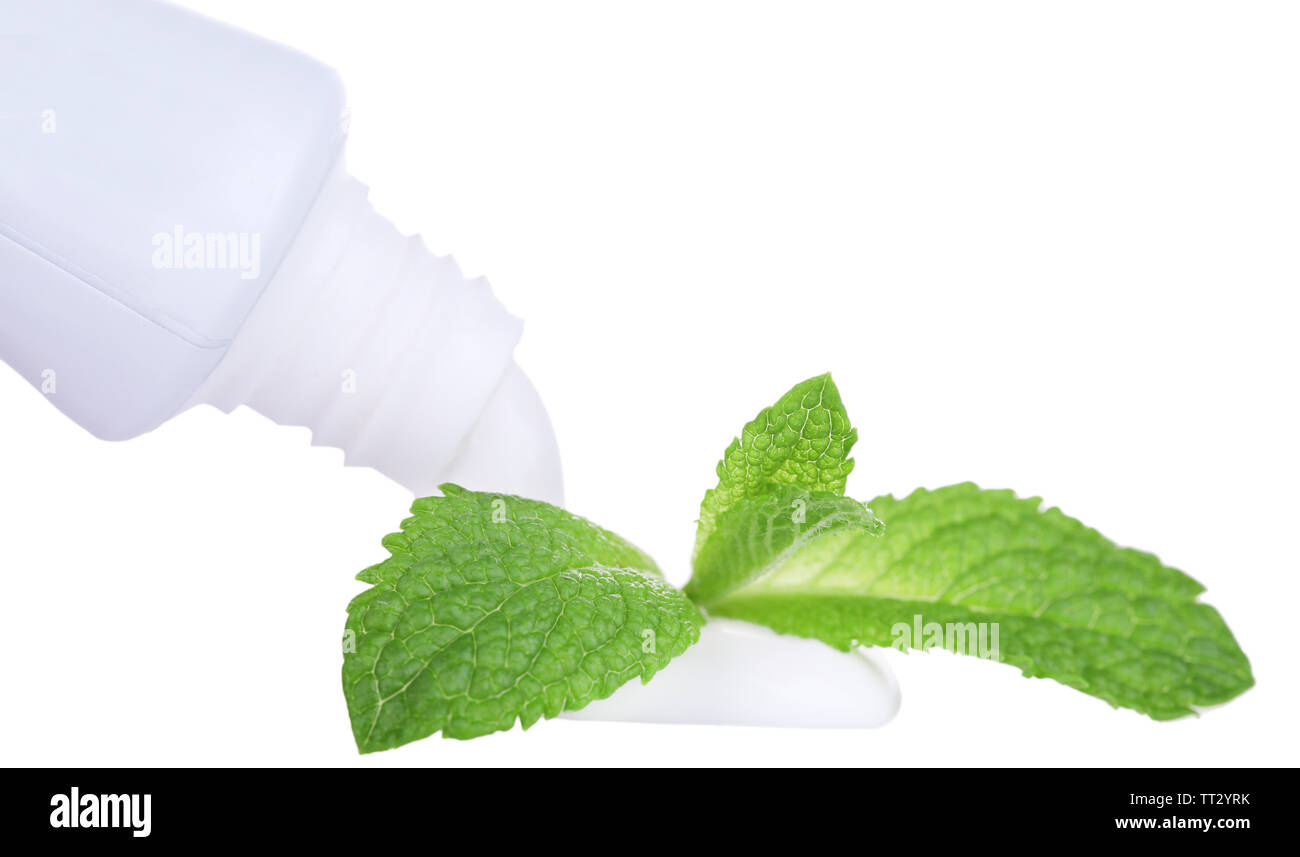 Toothpaste squeezed from tube, mint leaves, close-up, isolated on white ...
