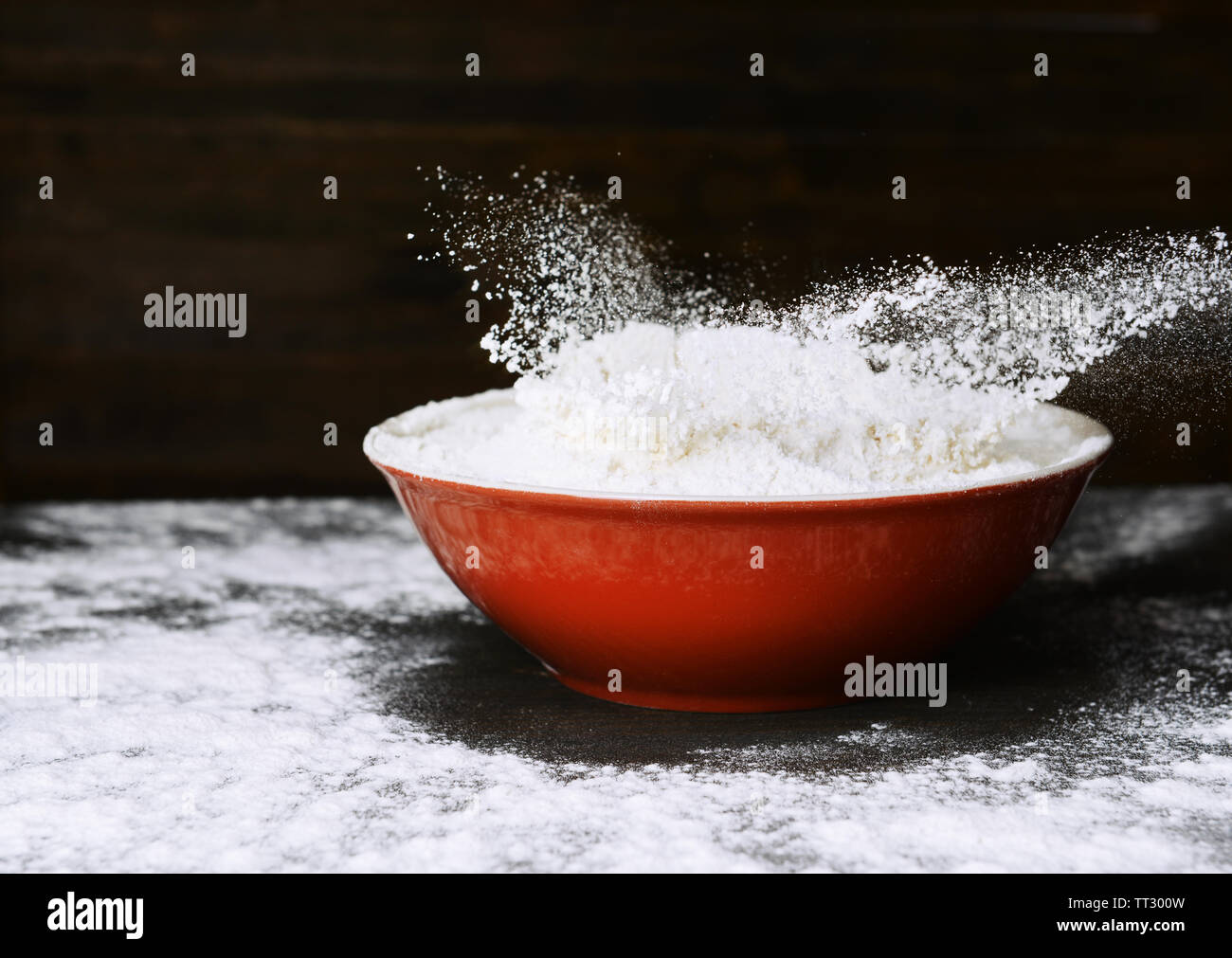 Flour in bowl on table on wooden background Stock Photo - Alamy