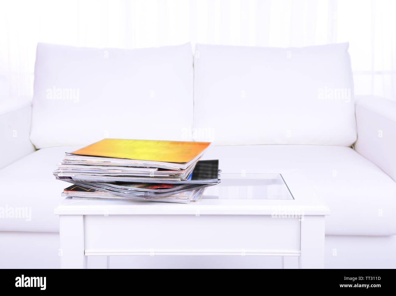 Magazines on coffee table in room Stock Photo - Alamy