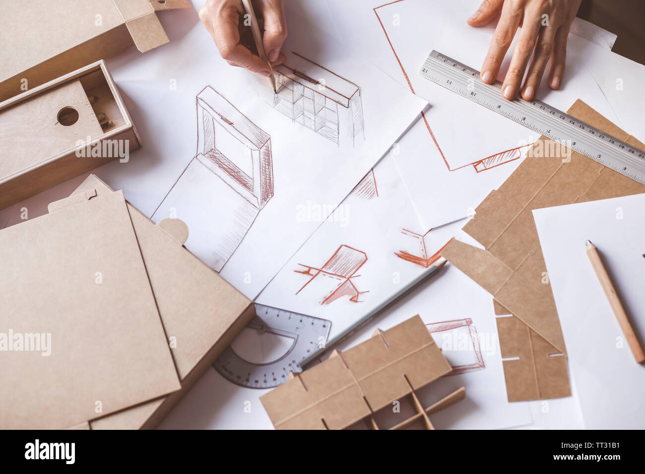Designer draws a mockup for crafting cardboard box. Development of ...
