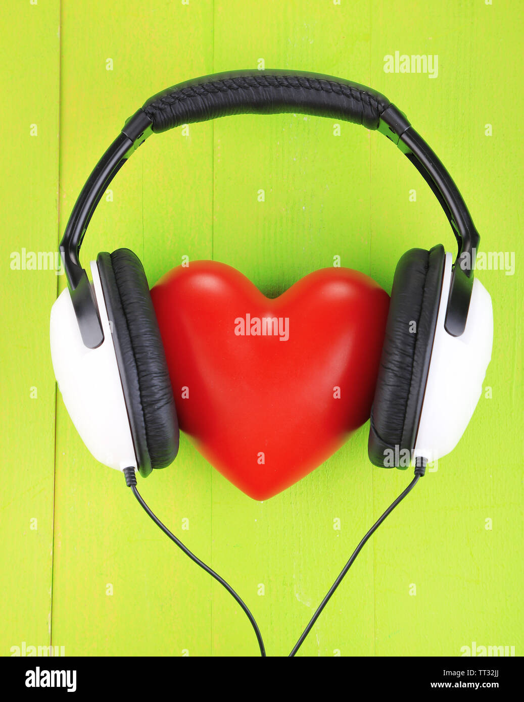 Headphones and heart on color wooden background Stock Photo - Alamy