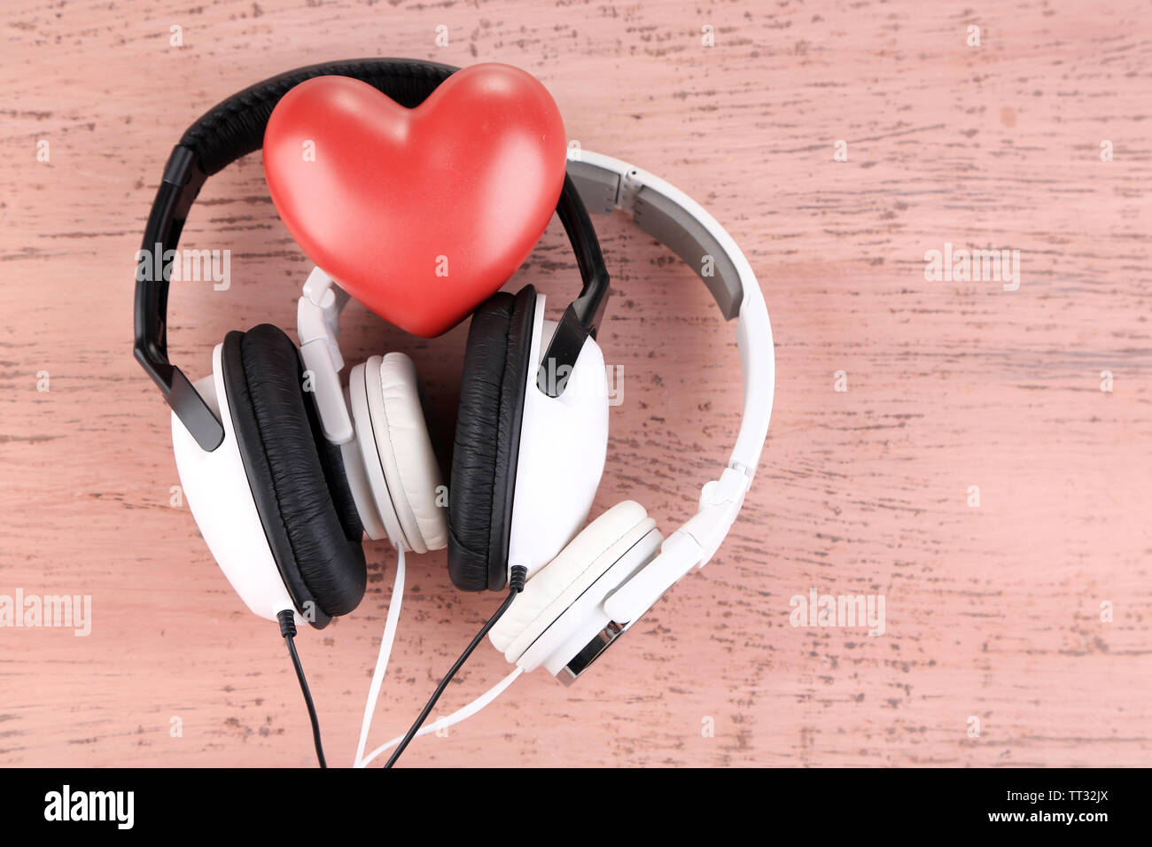 Headphones and heart on color wooden background Stock Photo - Alamy