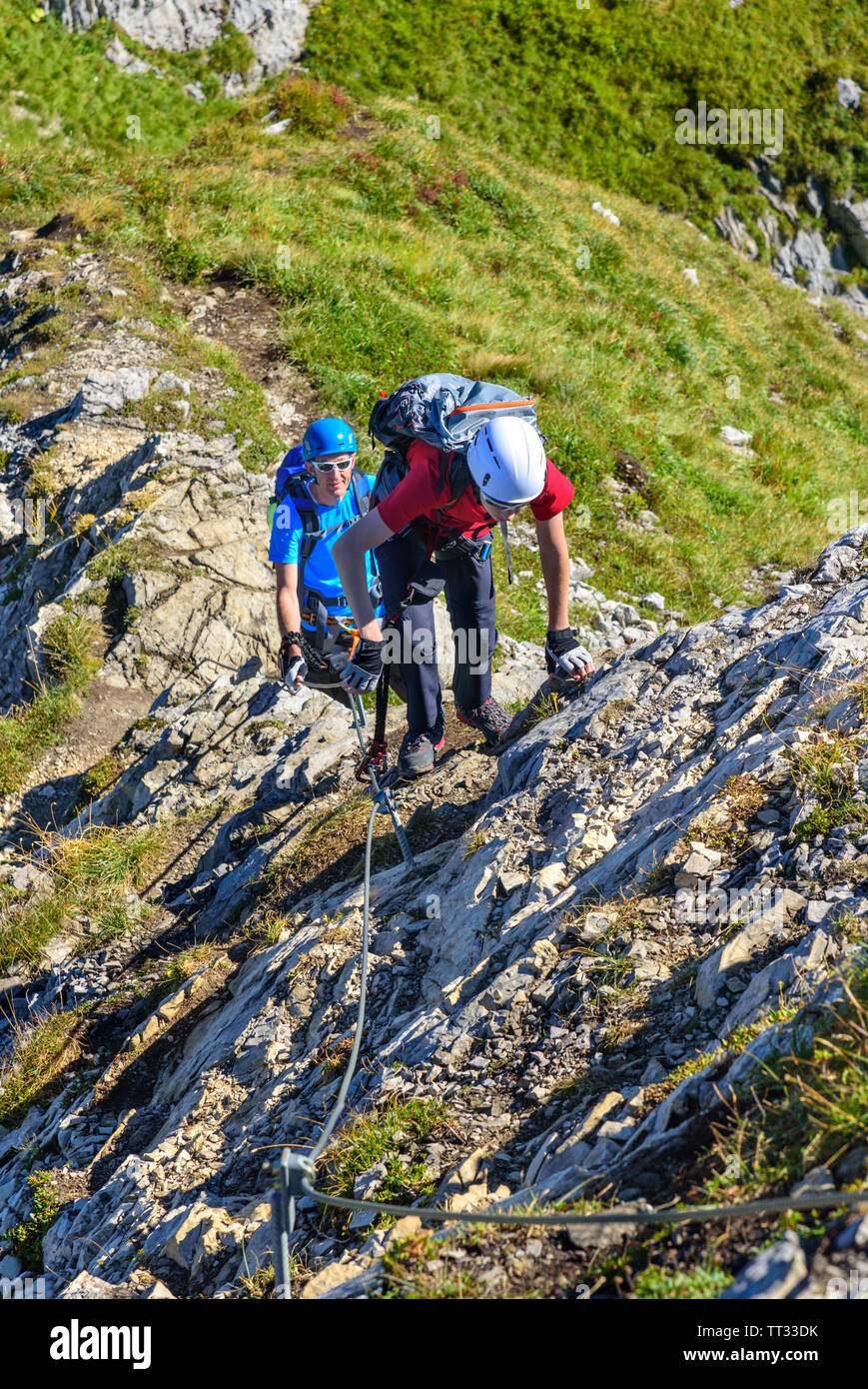 Climbing in via ferrata style in high alpine region in western Austria ...