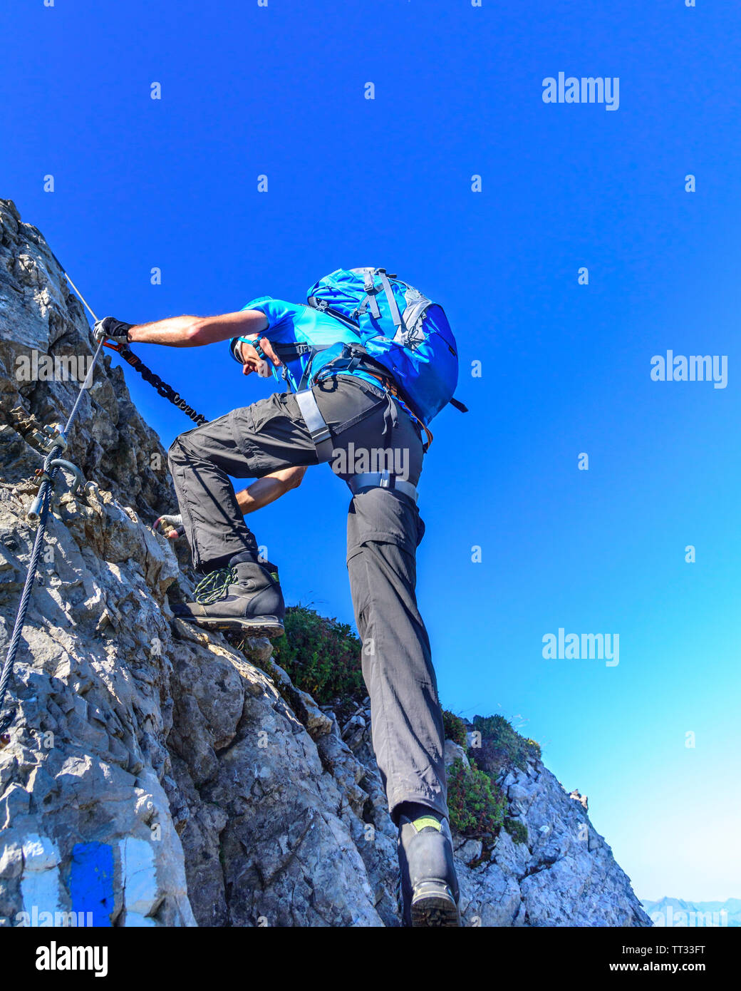 Climbing in via ferrata style in high alpine region in western Austria ...