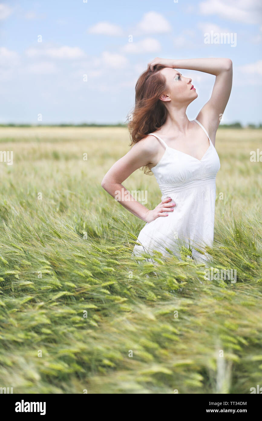 Beautiful young woman in field Stock Photo - Alamy